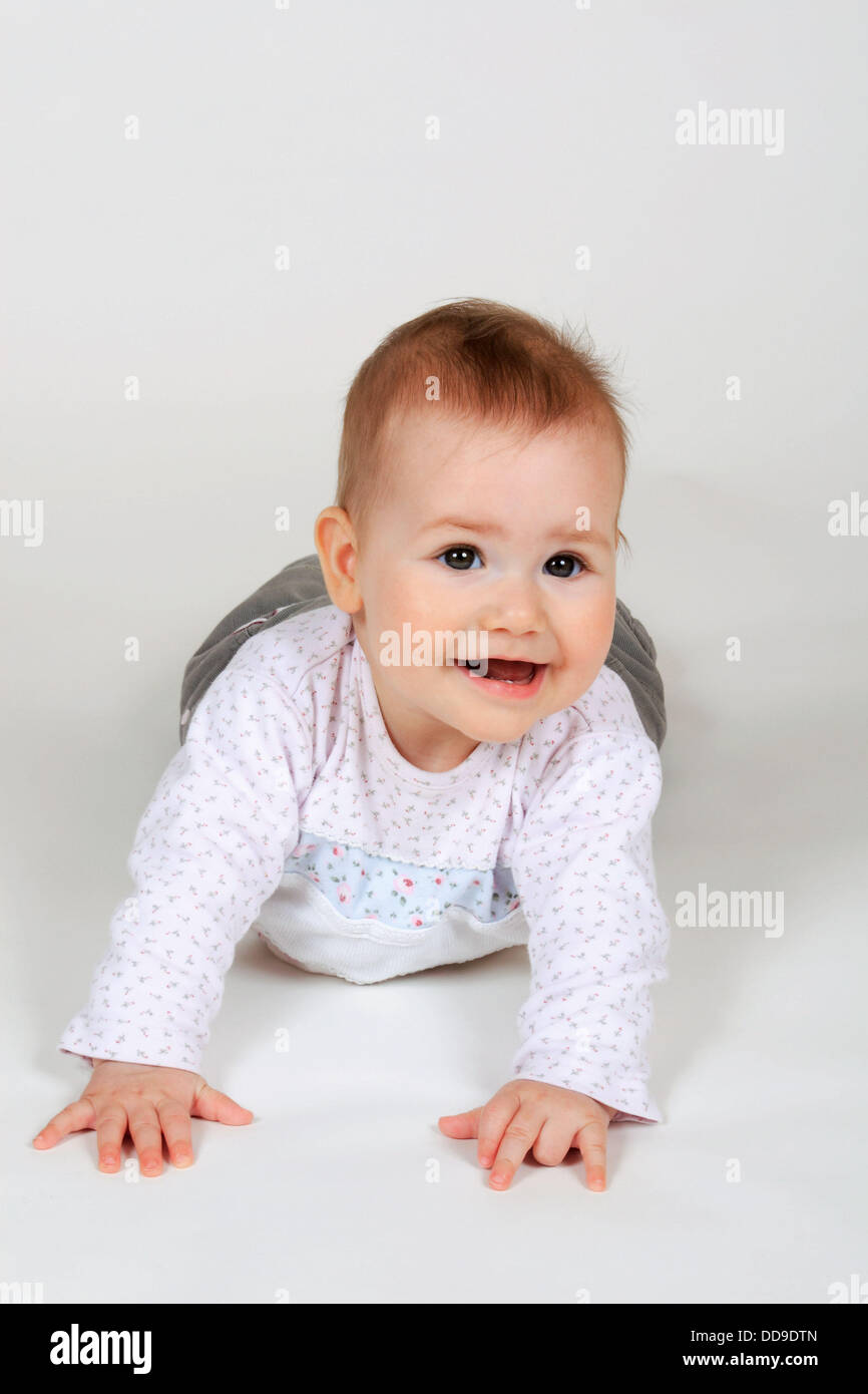 Baby lying on tummy, smiling Stock Photo - Alamy