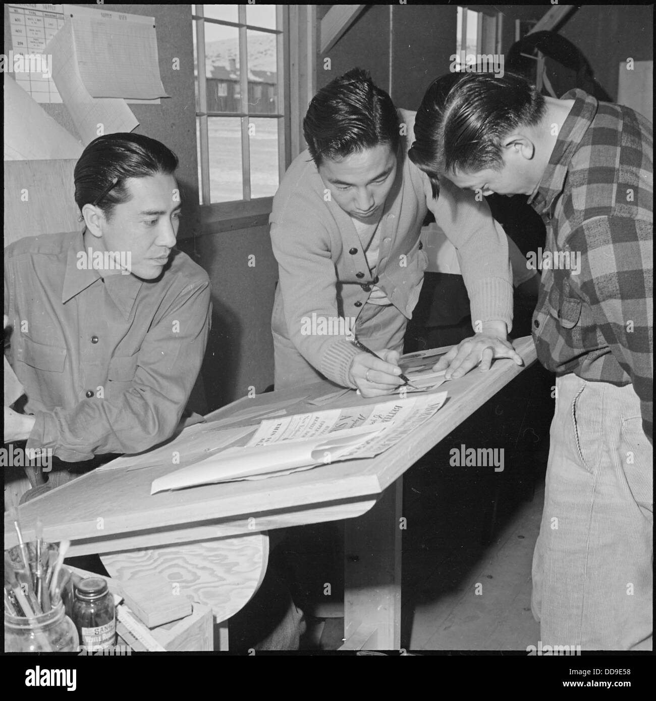 Three young artists are working in the Poster Shop at the Heart ...
