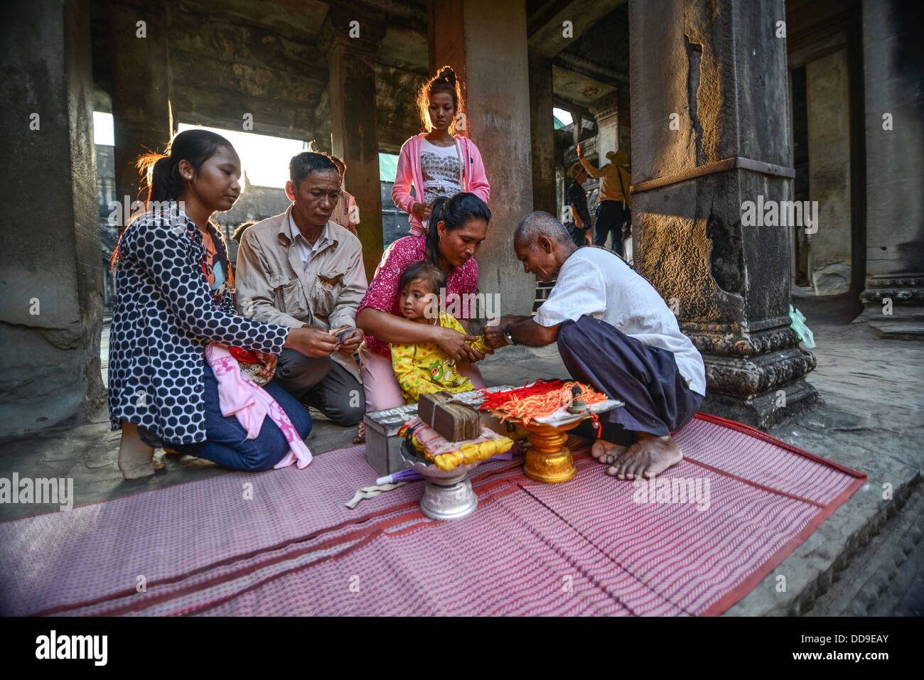 A Shamans prayer of blessing for the family at Angkor, Siem reap ...