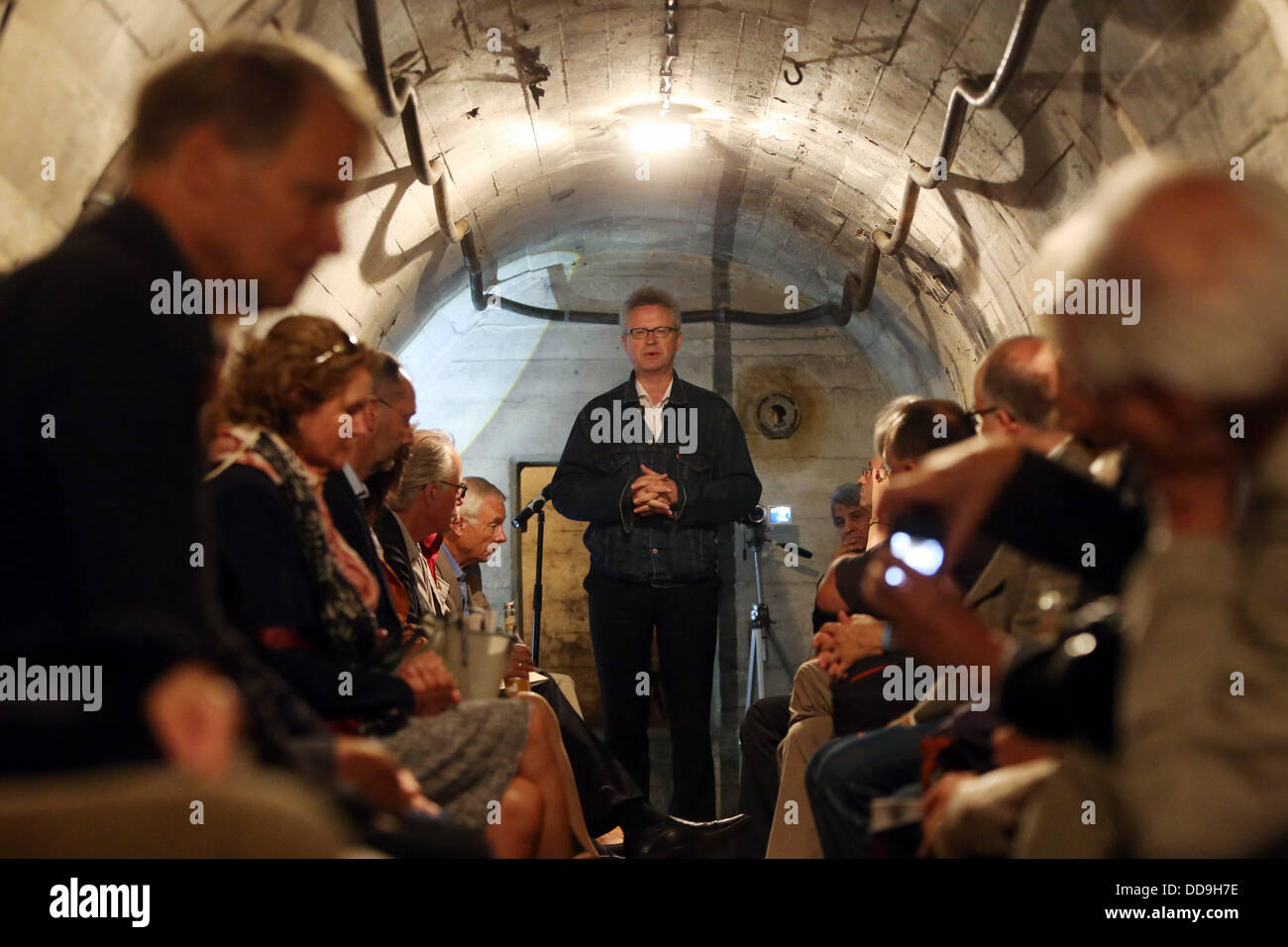 The artist Michael Batz talks to visitors as they sit in a former air ...