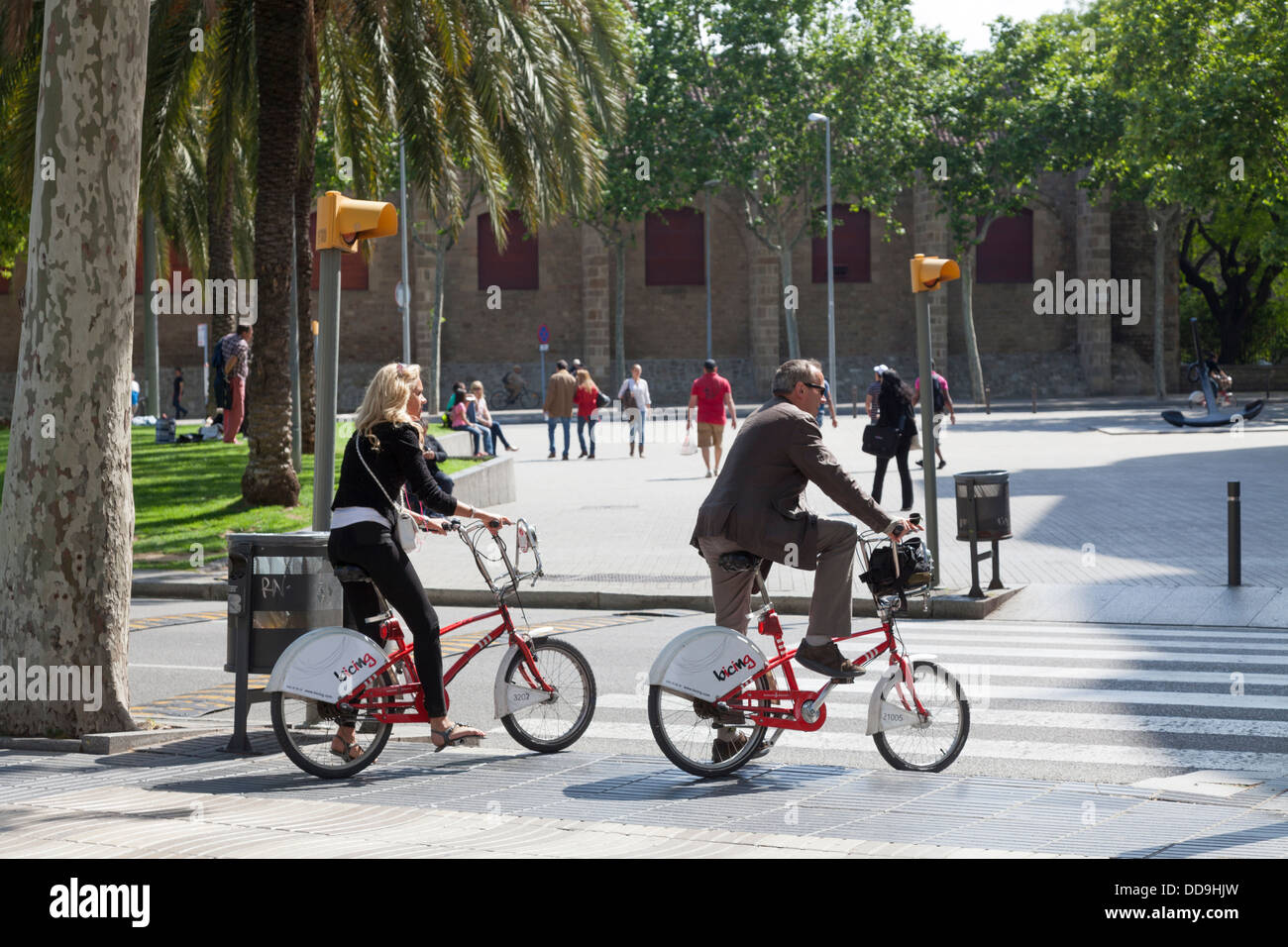 Two people riding Bicing Barcelona bicycle sharing cycles Stock Photo ...