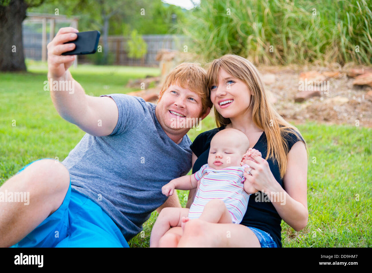 Family taking picture of themselves, smiling Stock Photo - Alamy