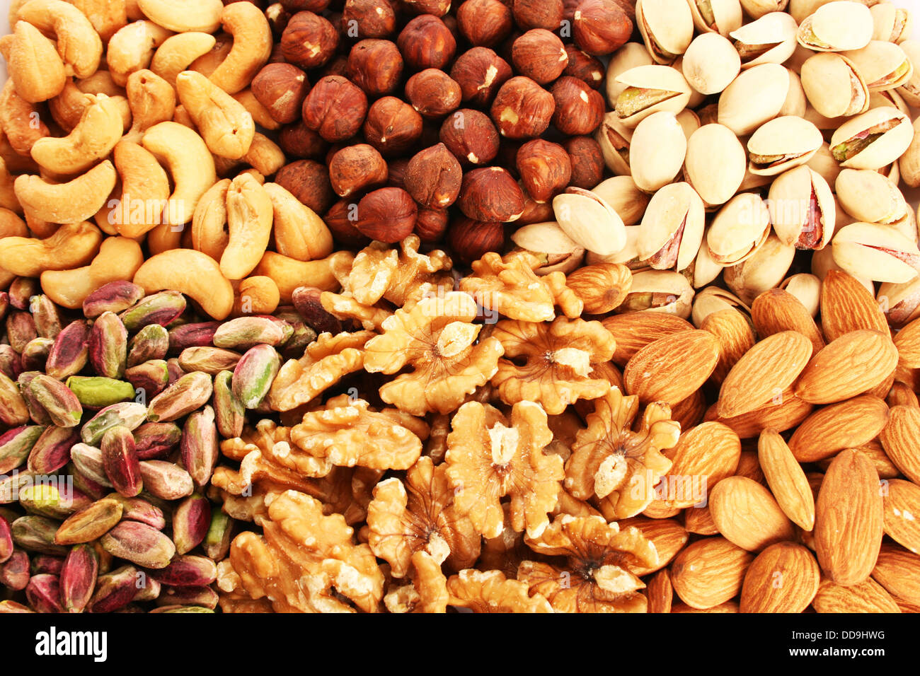 Different nuts as a background Stock Photo - Alamy