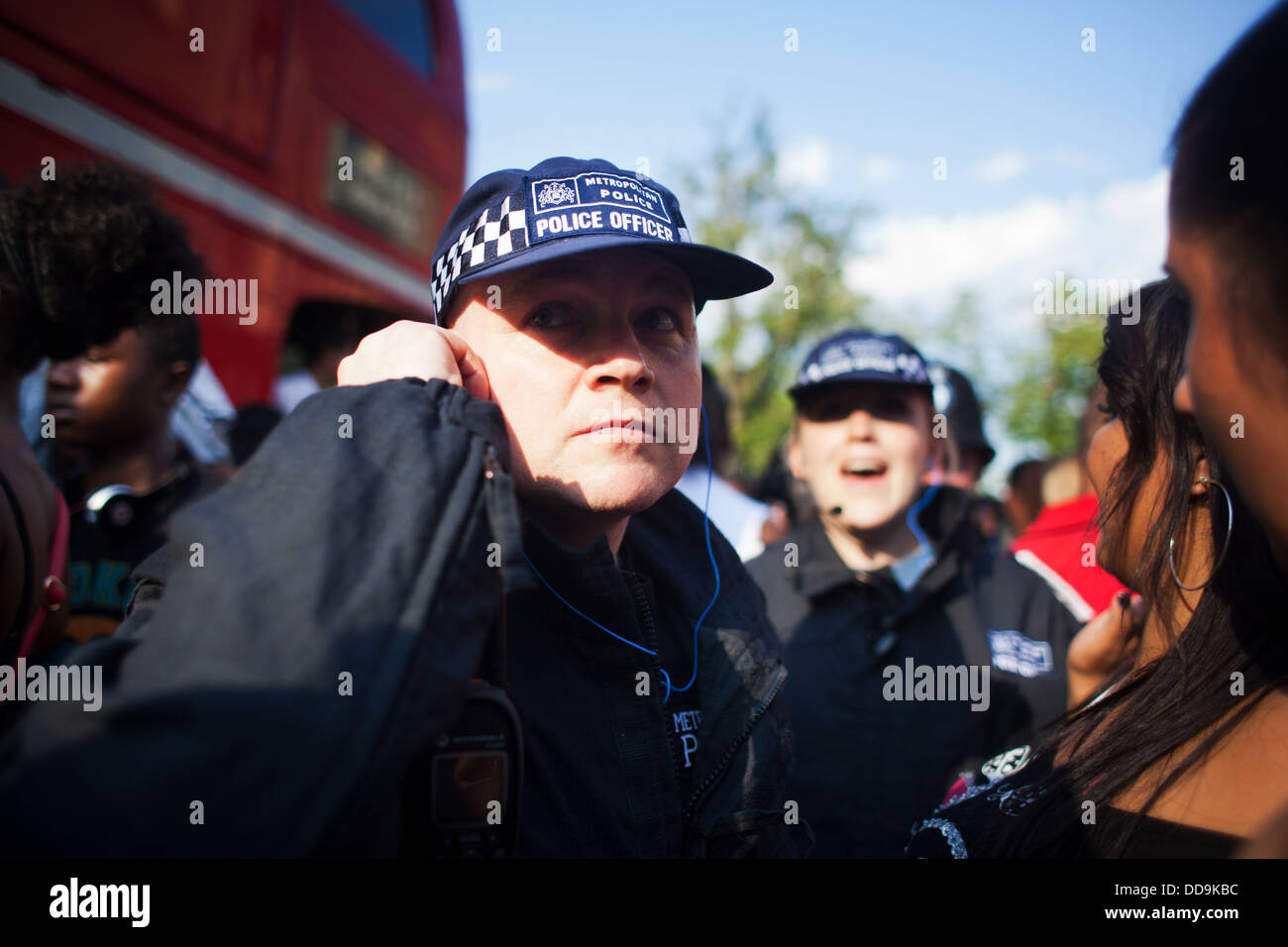Two white police officers wearing blue police caps and head-sets in the ...
