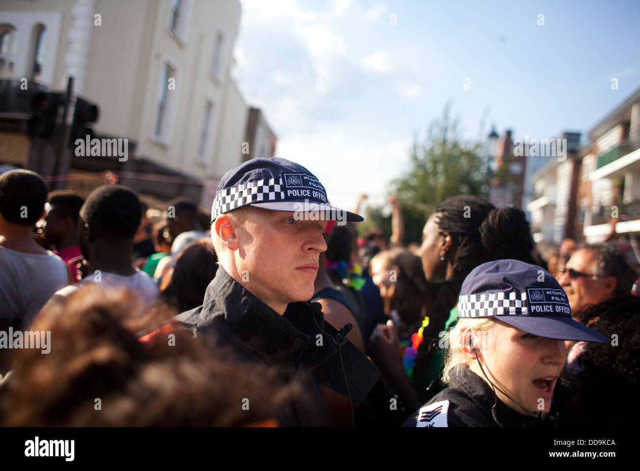 Two white police officers wearing blue police caps and head-sets in the ...