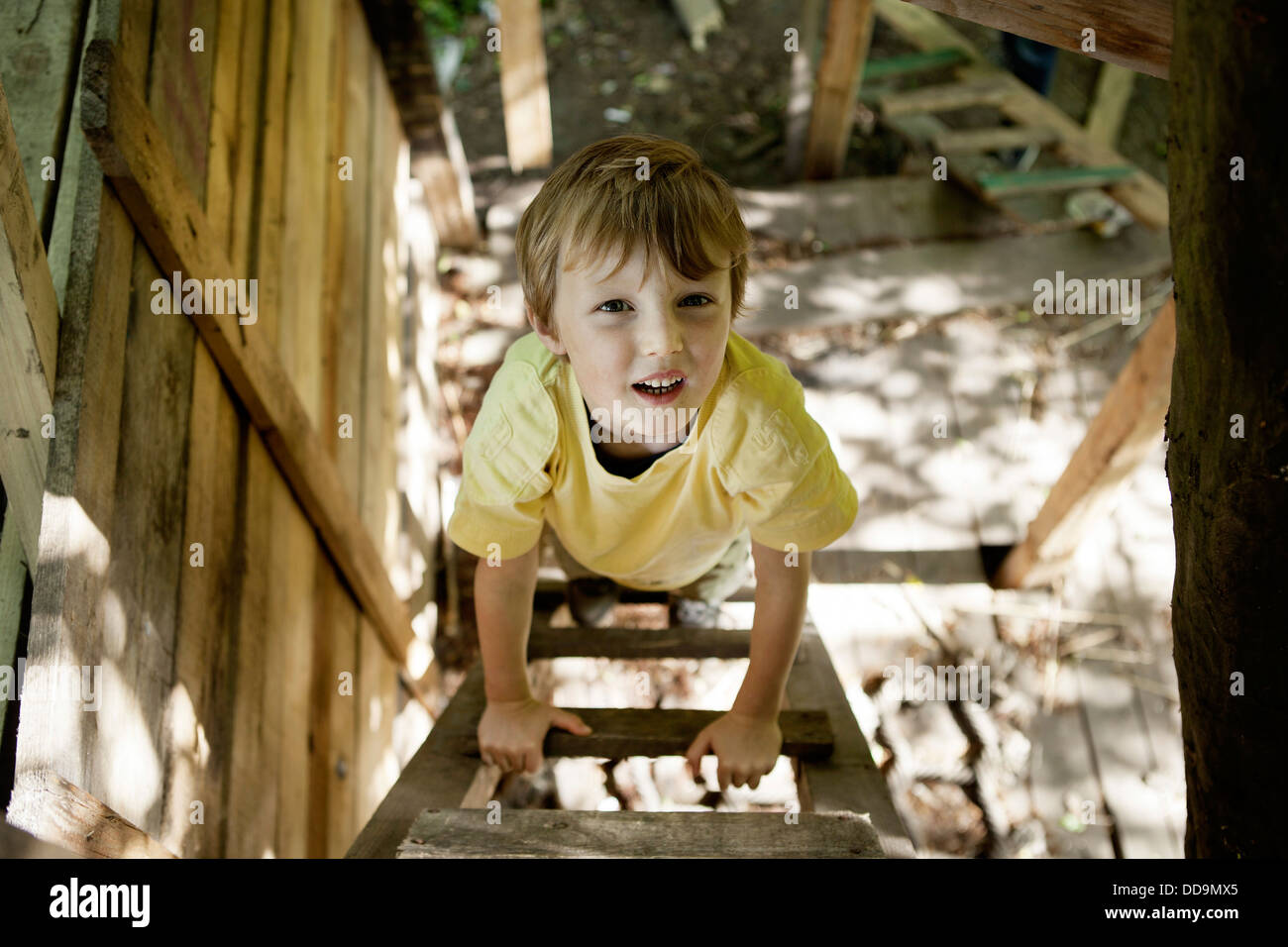 Boy climbing steps ladder hi-res stock photography and images - Alamy