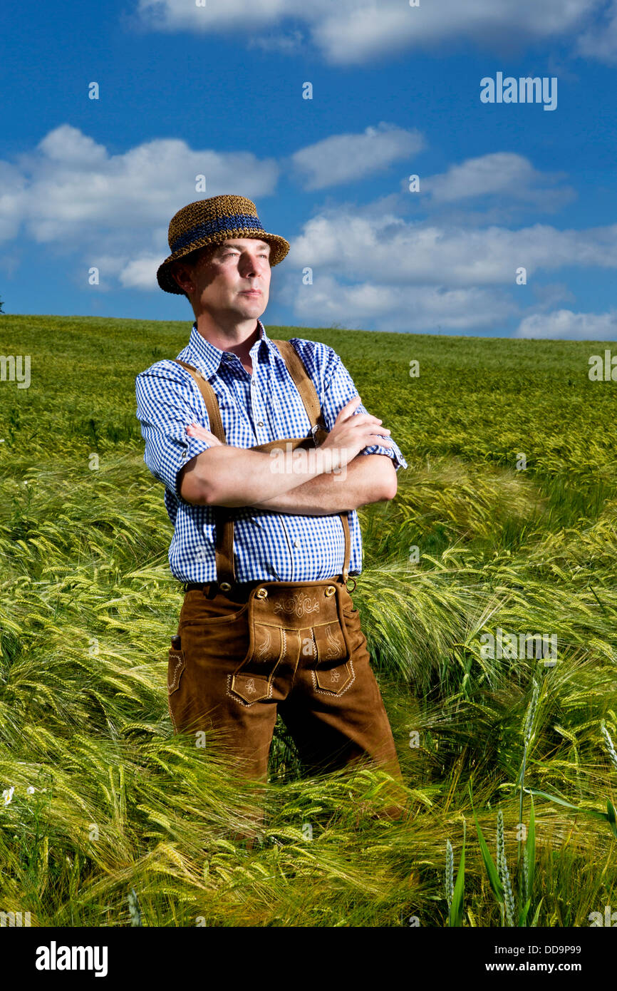 Germany, Bavaria, Farmer standing in field with arms crossed Stock ...