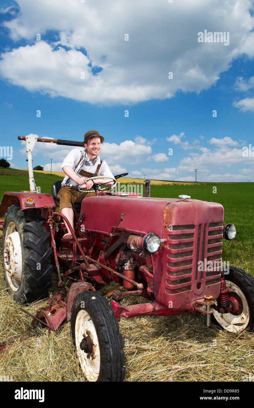Germany, Bavaria, Farmer in tractor, smiling Stock Photo - Alamy