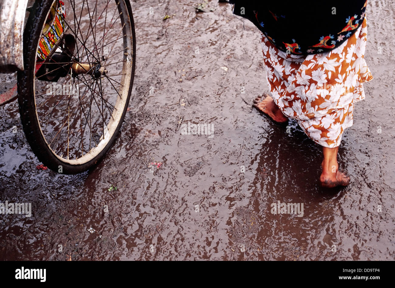 Woman walking barefoot in mud hi-res stock photography and images - Alamy