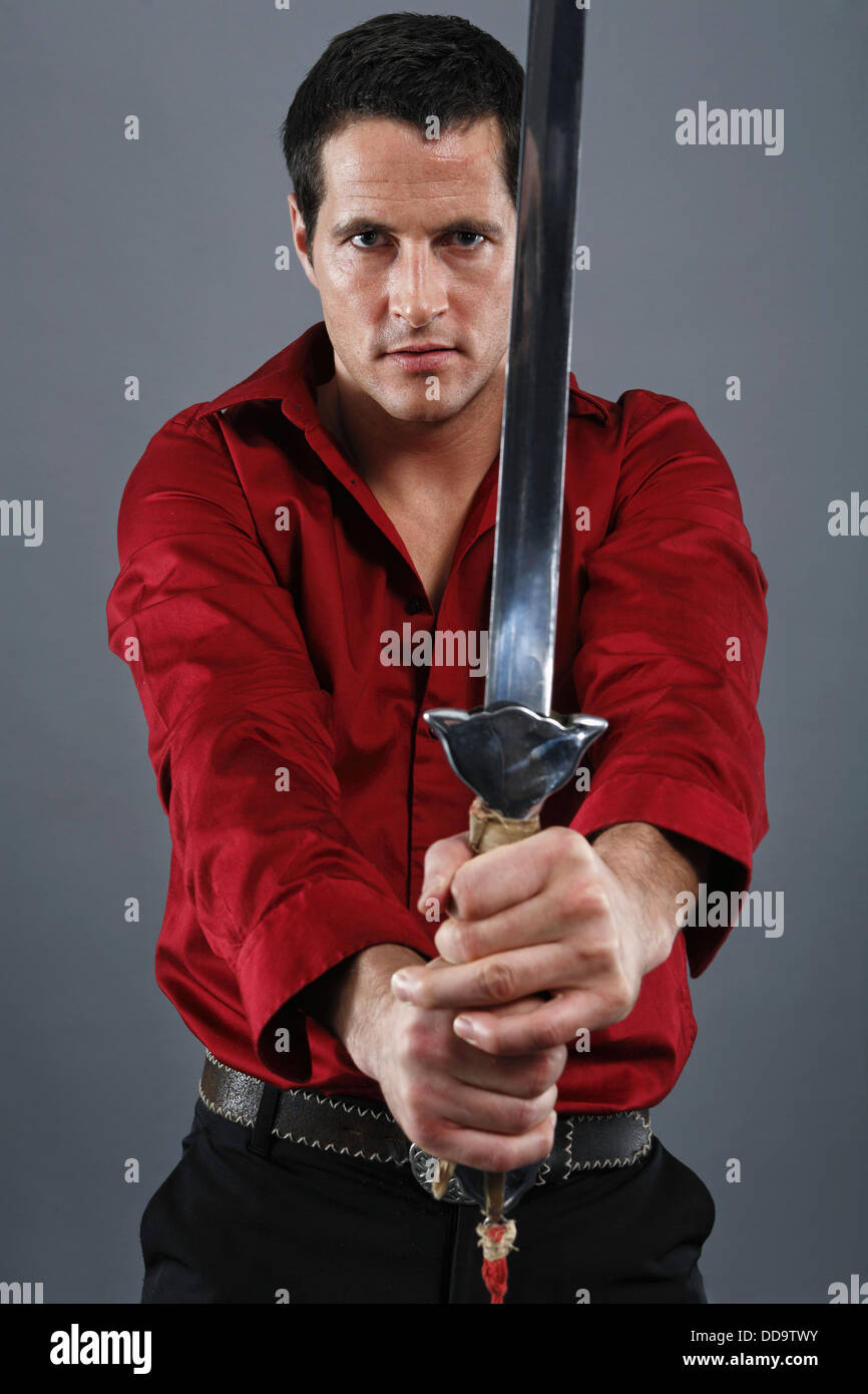 Portrait of man holding sword Stock Photo - Alamy