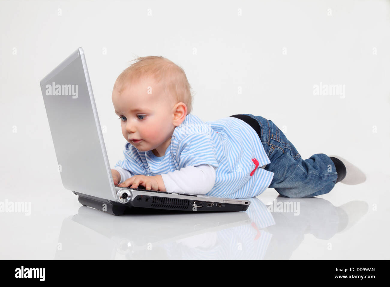 Baby boy using laptop on white background, smiling Stock Photo - Alamy