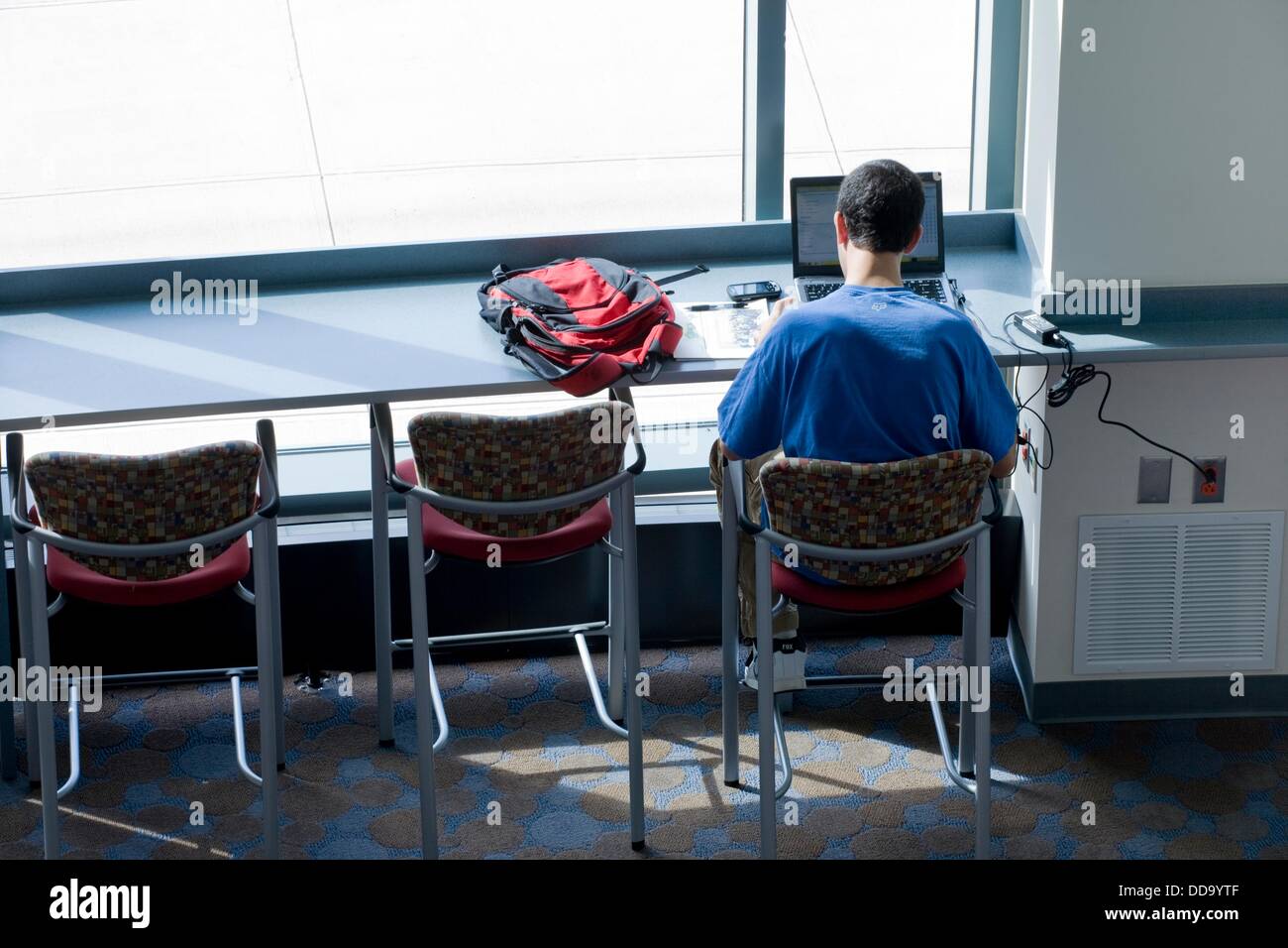 College student working on his laptop computer Stock Photo - Alamy