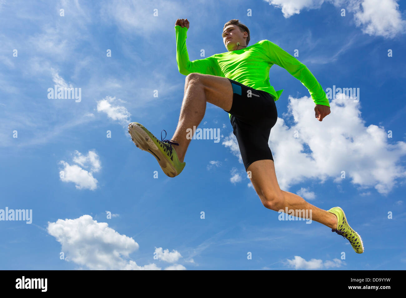 Young man doing long jump in track hi-res stock photography and images ...