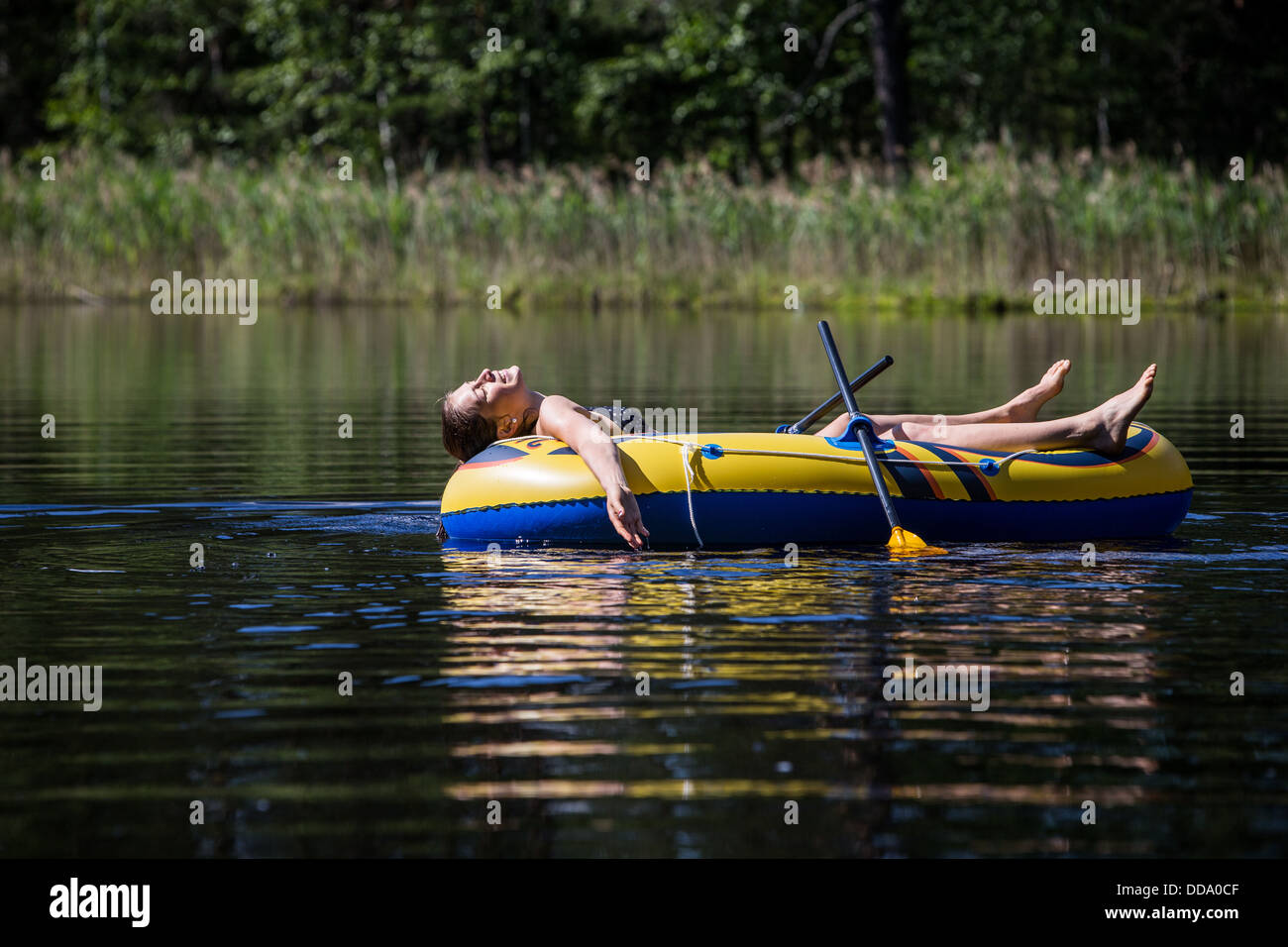 Woman sunbathing on inflatable boat hi-res stock photography and images ...
