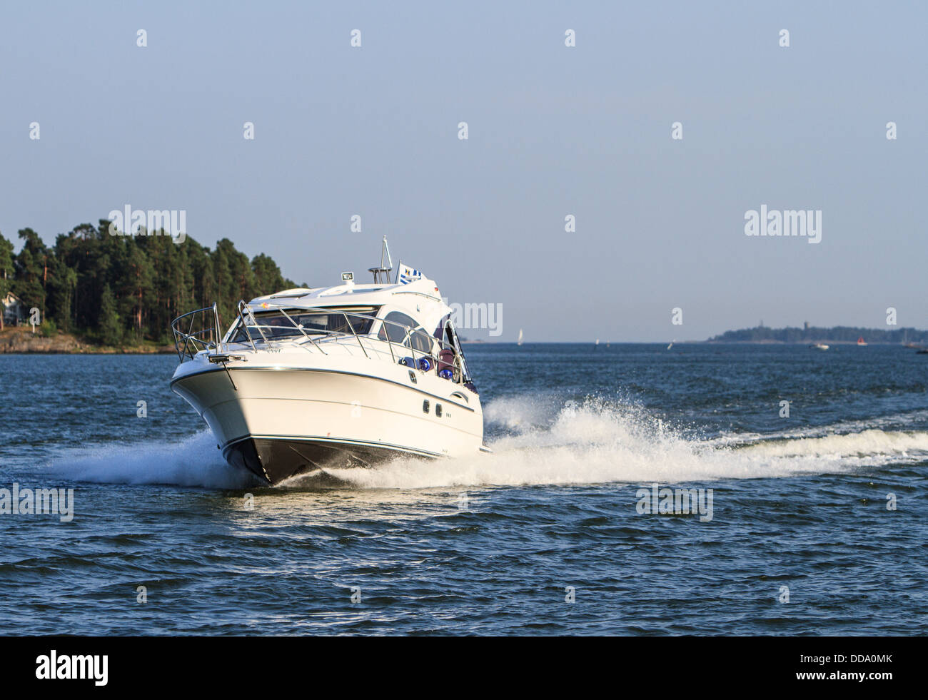 A white motorboat approaching fast Stock Photo - Alamy