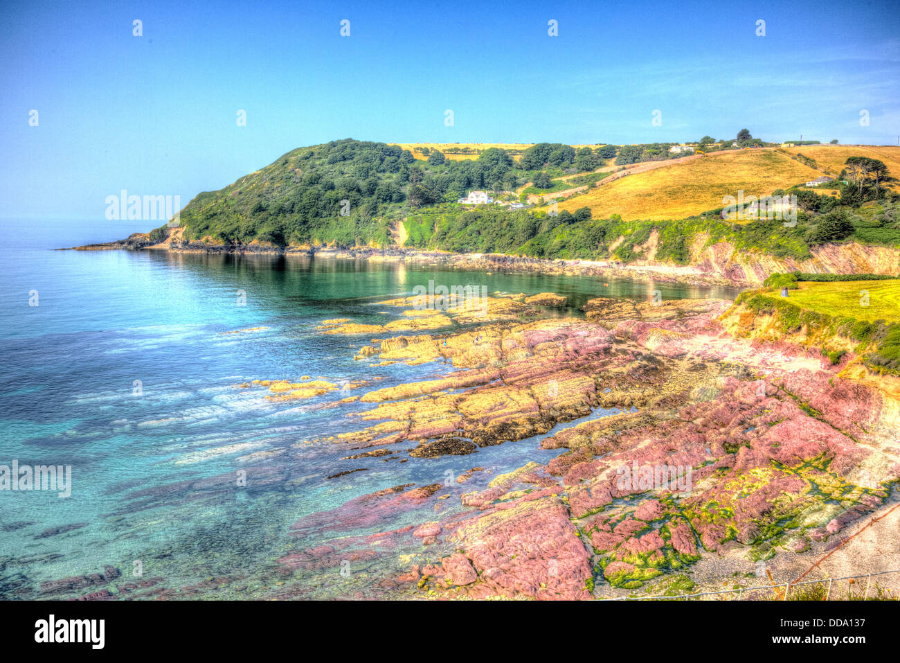 Coast of Cornwall bay with red rock and vivid colours at Talland Bay in ...
