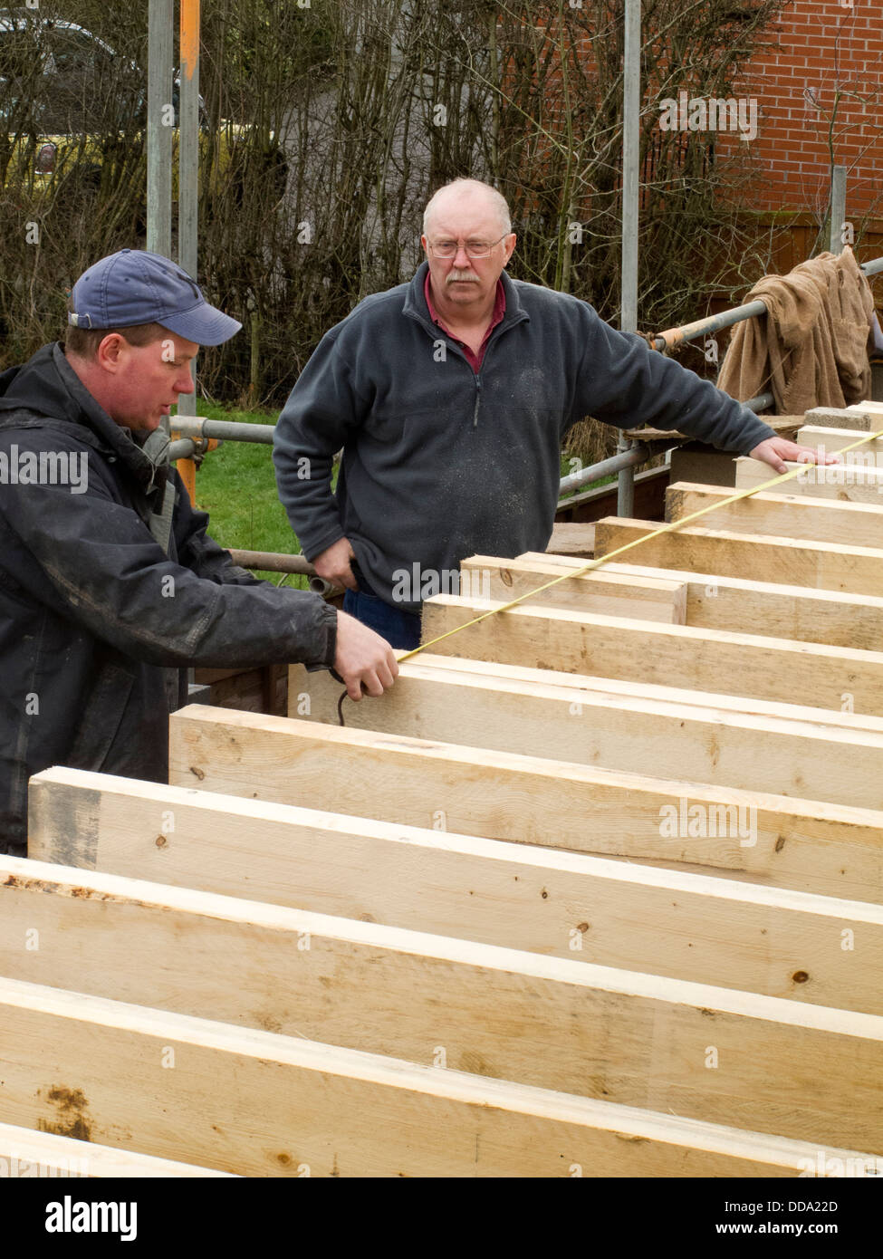 self building house, constructing upper floor, manually measuring joist ...