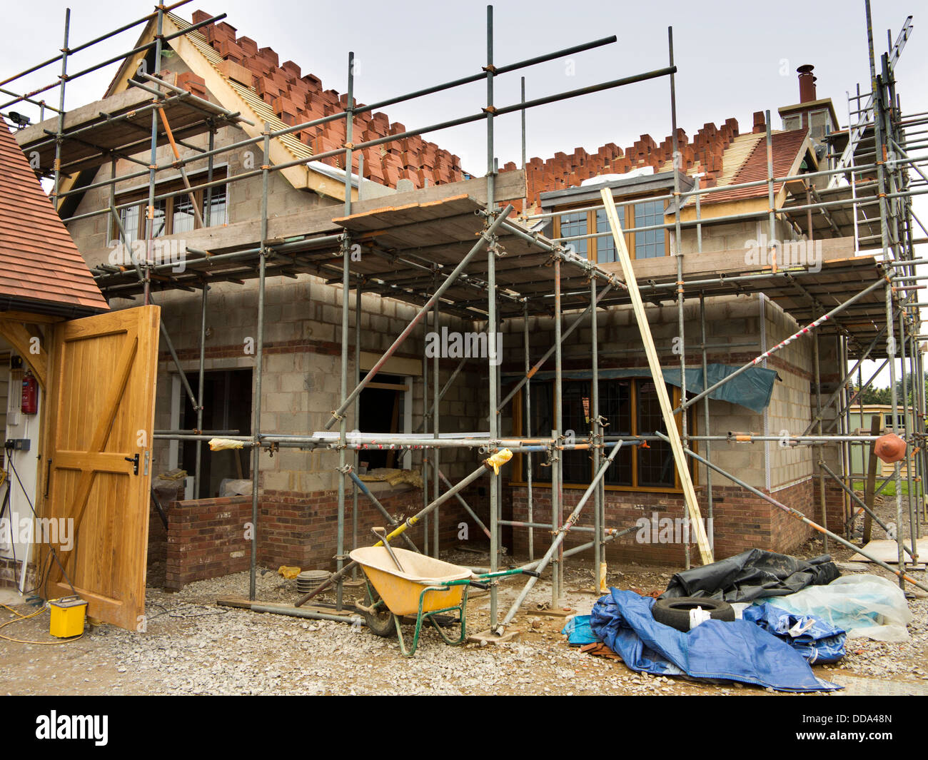 self building house, constructing roof, clay tiles stacked on laths ...