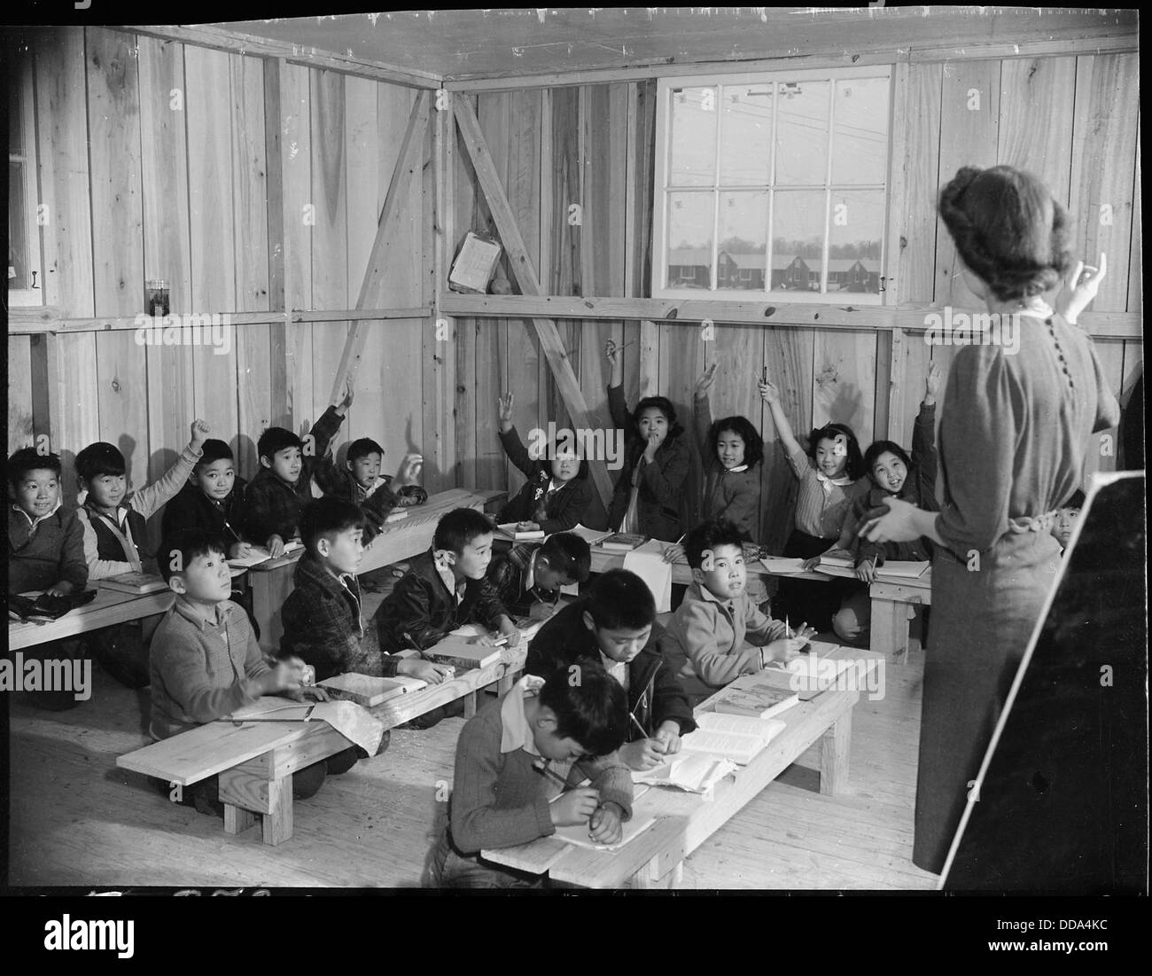 This image depicts a third-grade class at the Rohwer Relocation Center ...
