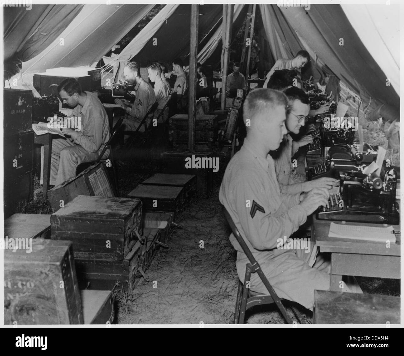 U.S. Army personnel are seen performing clerical work in the field ...