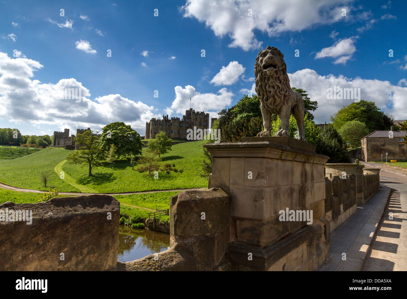 Alnwick castle and lion statue on a bridge Stock Photo - Alamy