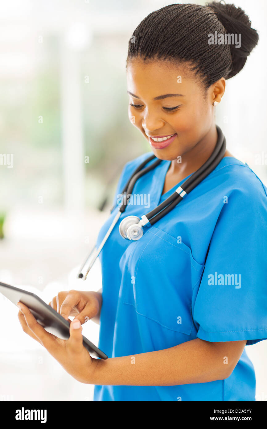 pretty afro American nurse using tablet pc Stock Photo - Alamy