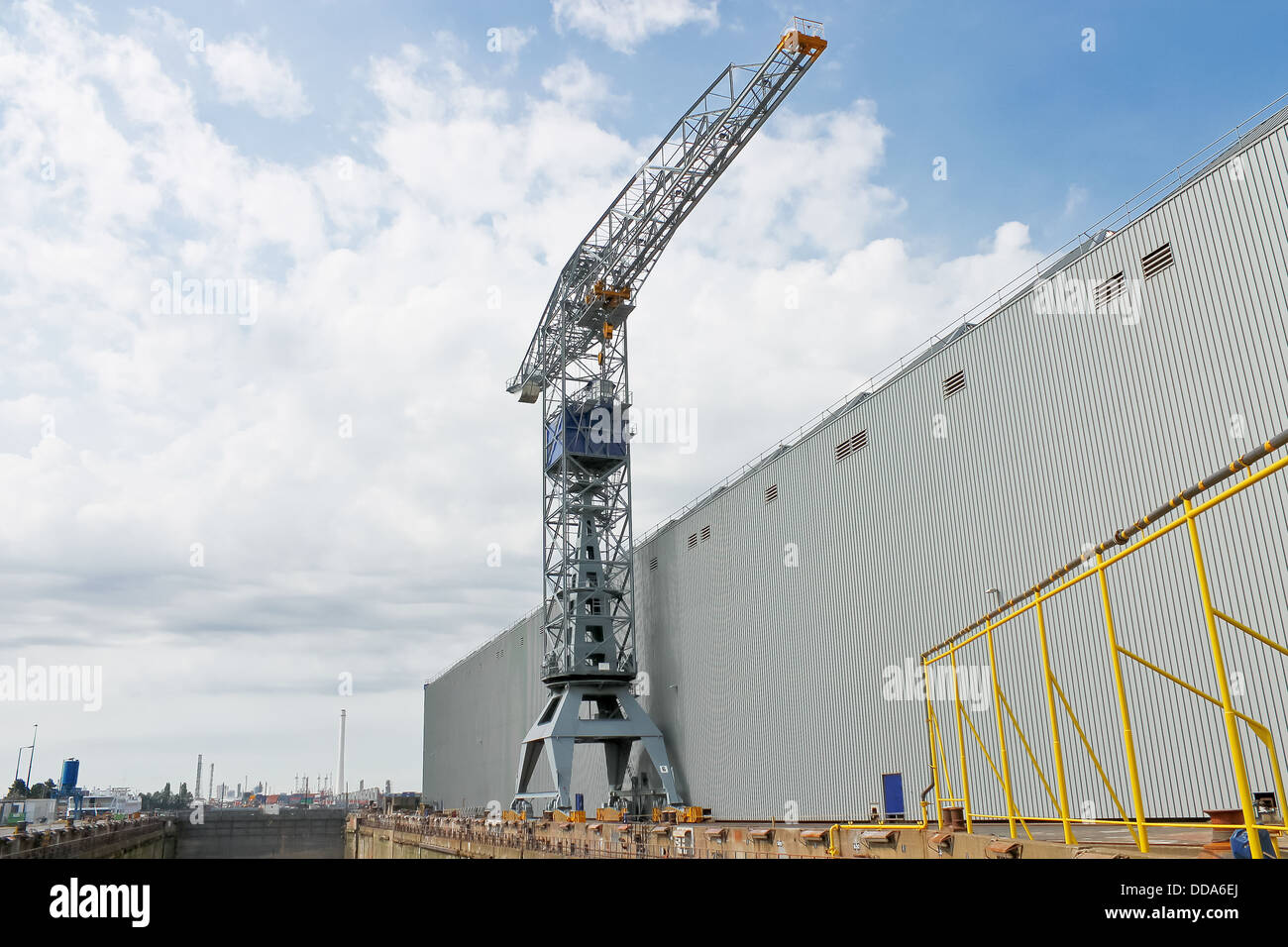 Crane near a covered dry dock at the shipyard Stock Photo - Alamy