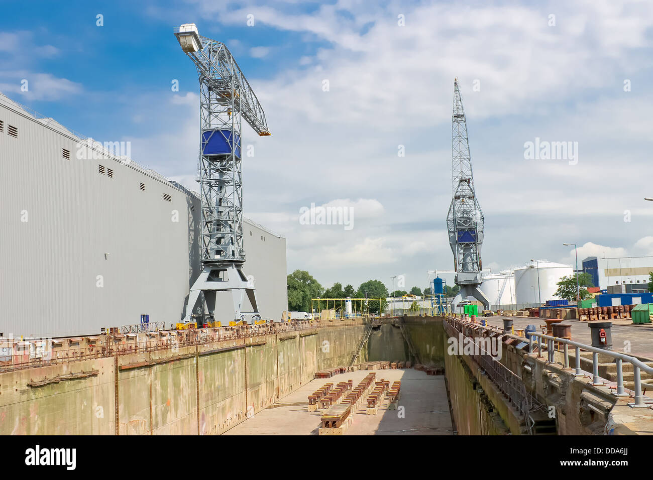 Crane near a covered dry dock at the shipyard Stock Photo - Alamy