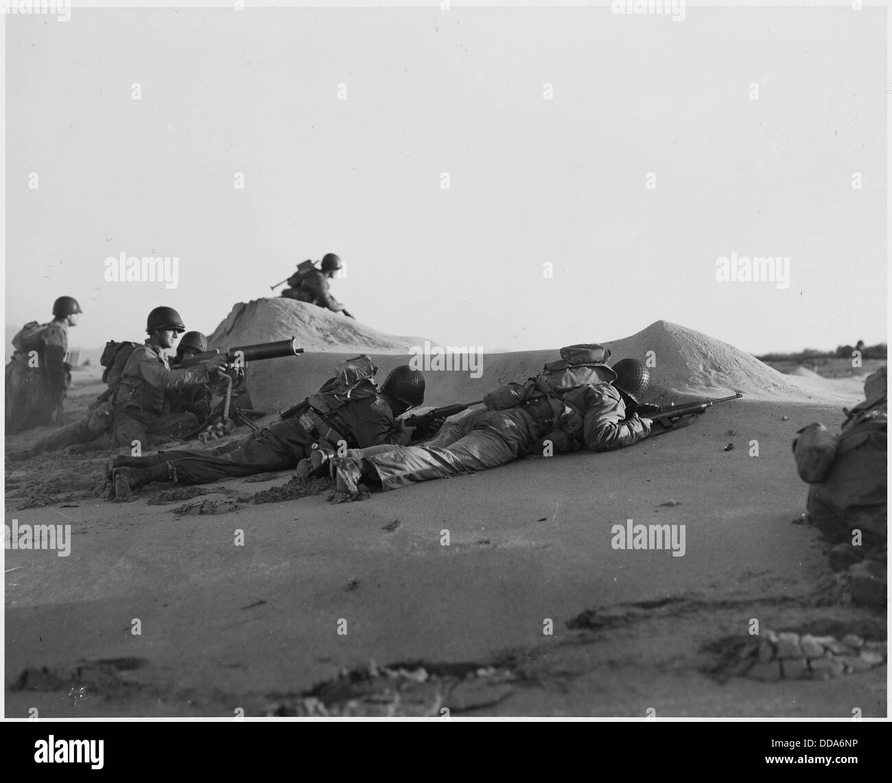 The image shows military personnel performing maneuvers at a training ...