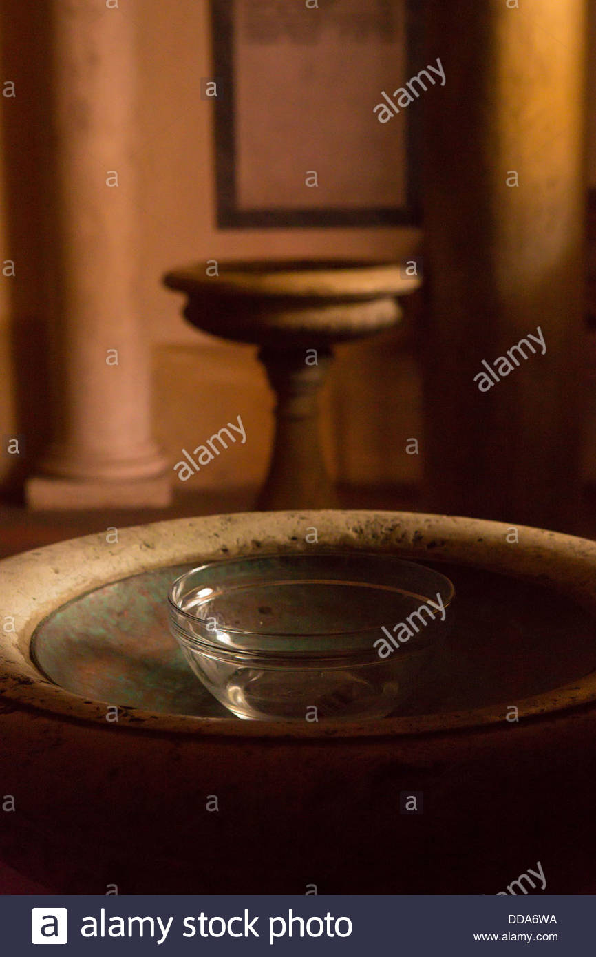 A stone font is part of a Roman Catholic church interior Stock Photo ...