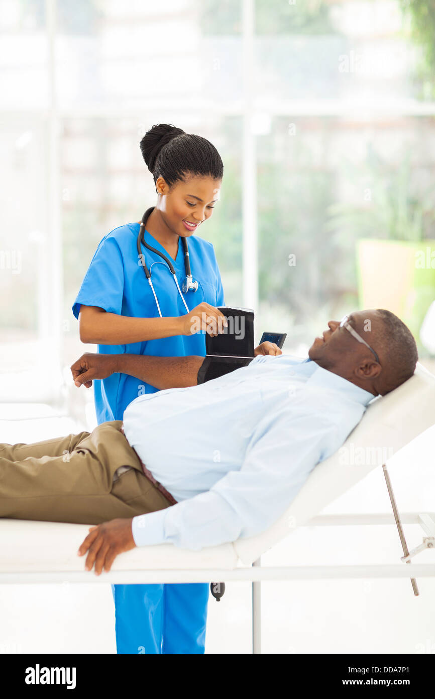 Black nurse measure female patient hi-res stock photography and images ...