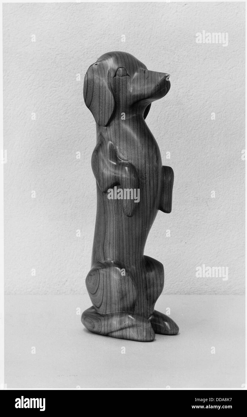 This photograph showcases a wood carving of a dog by James Bradley ...