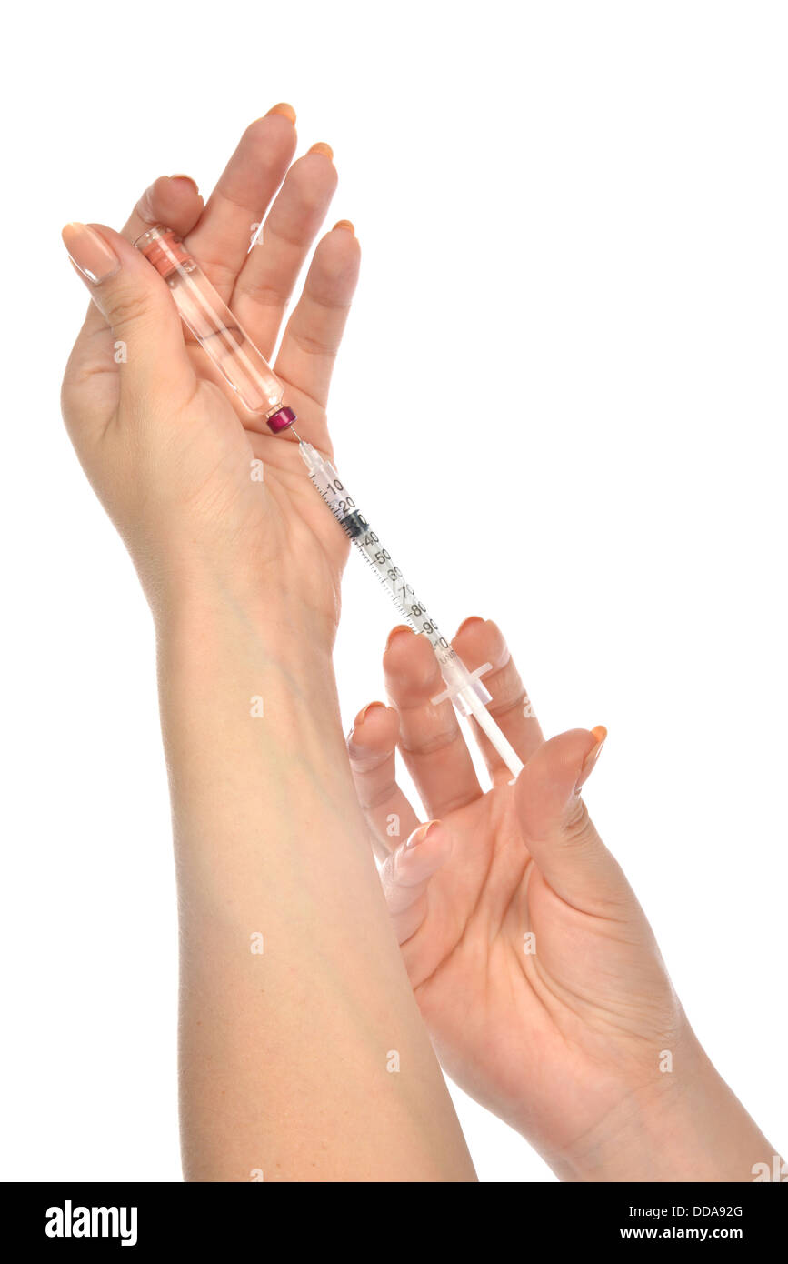 Doctor hands with medical syringe with needle in ampule getting ready ...