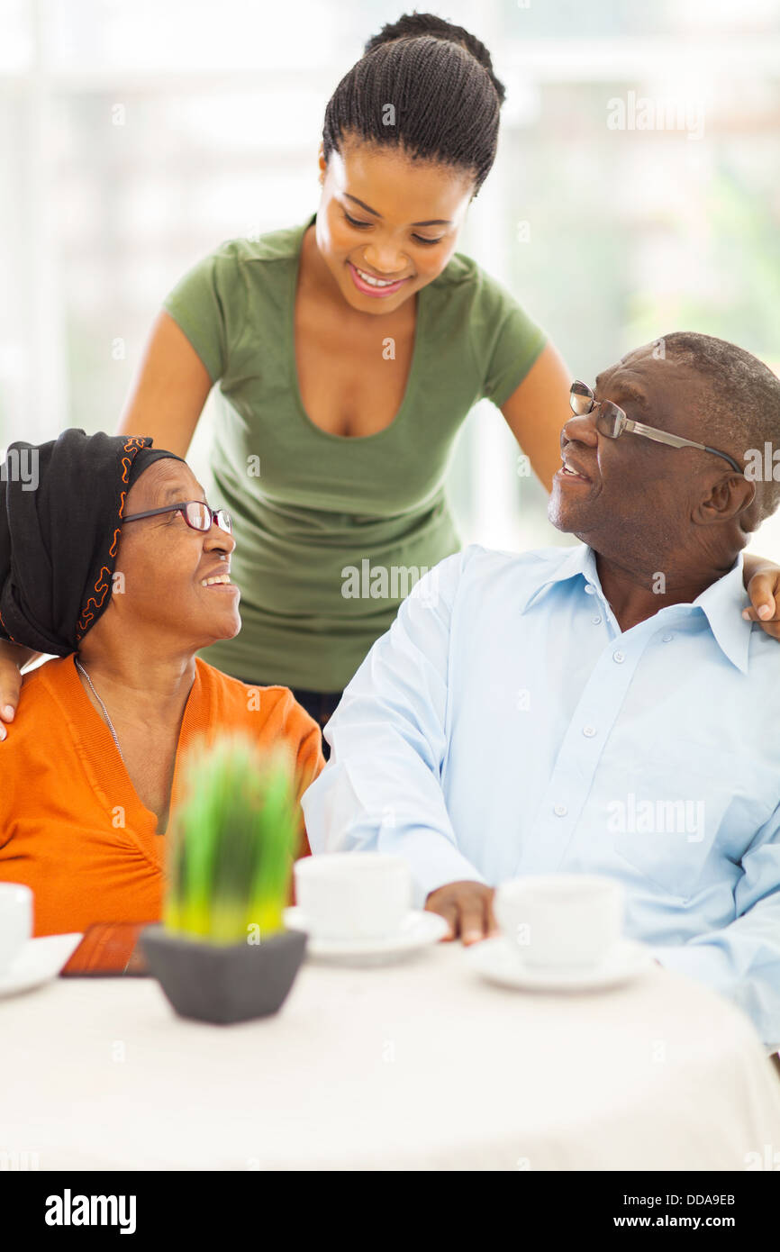 beautiful African girl talking to senior parents at home Stock Photo ...