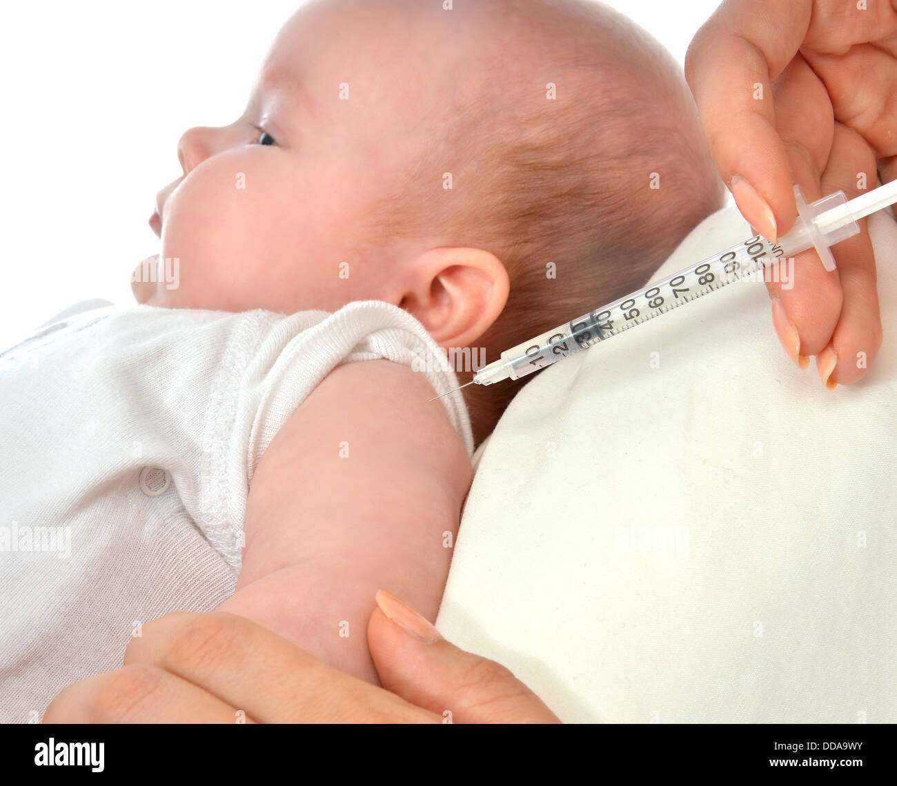 Doctors hand with syringe vaccinating child baby flu injection shot ...