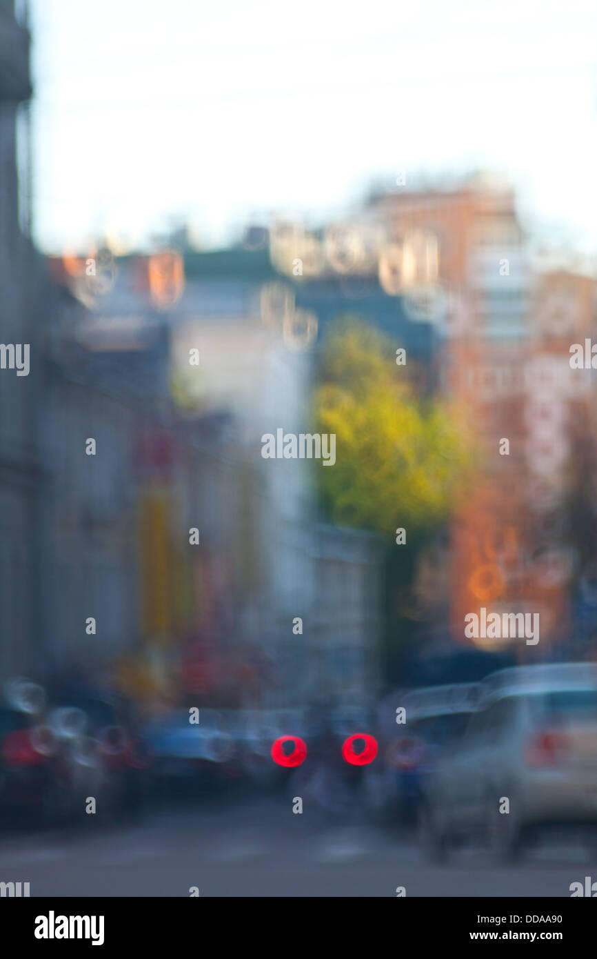 Blurred movement of people and cars in the city. The halo effect around ...