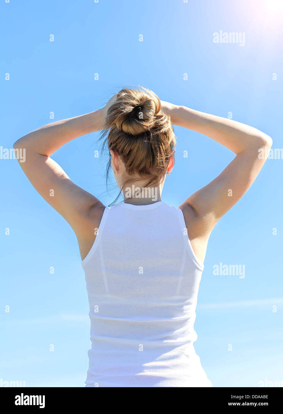 Female back view over blue sky Stock Photo - Alamy