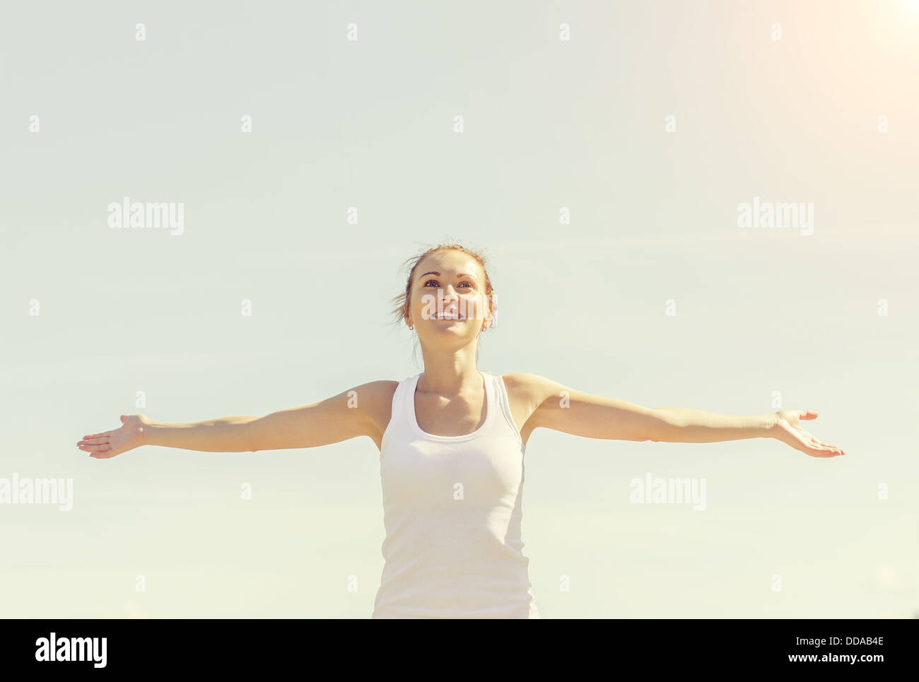 Young smiling female with arms wide open Stock Photo - Alamy