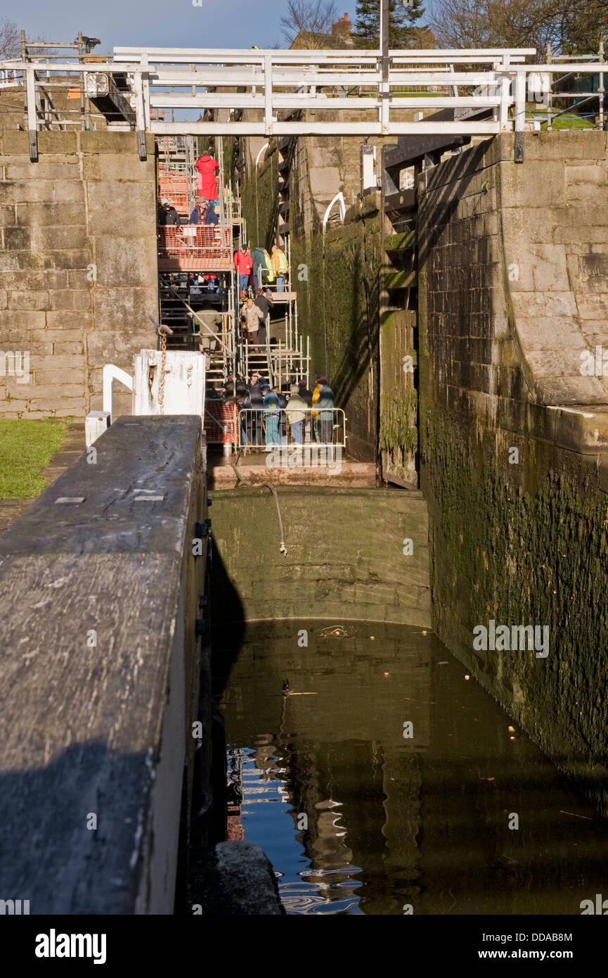 People inside a drained lock chamber, walking round & looking at ...