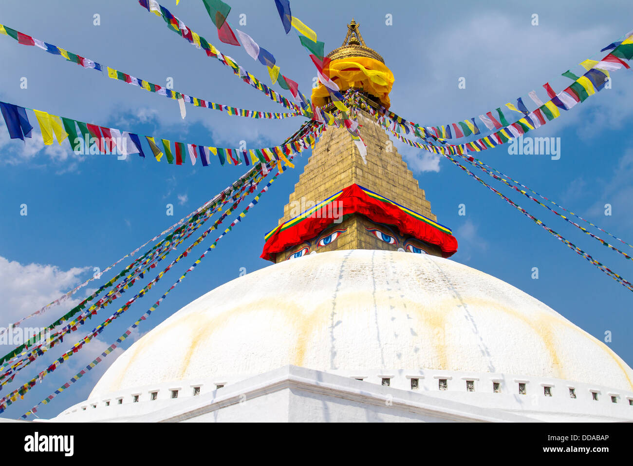 Buddhist shrine Boudhanath Stupa with Buddha wisdom eyes and praying ...