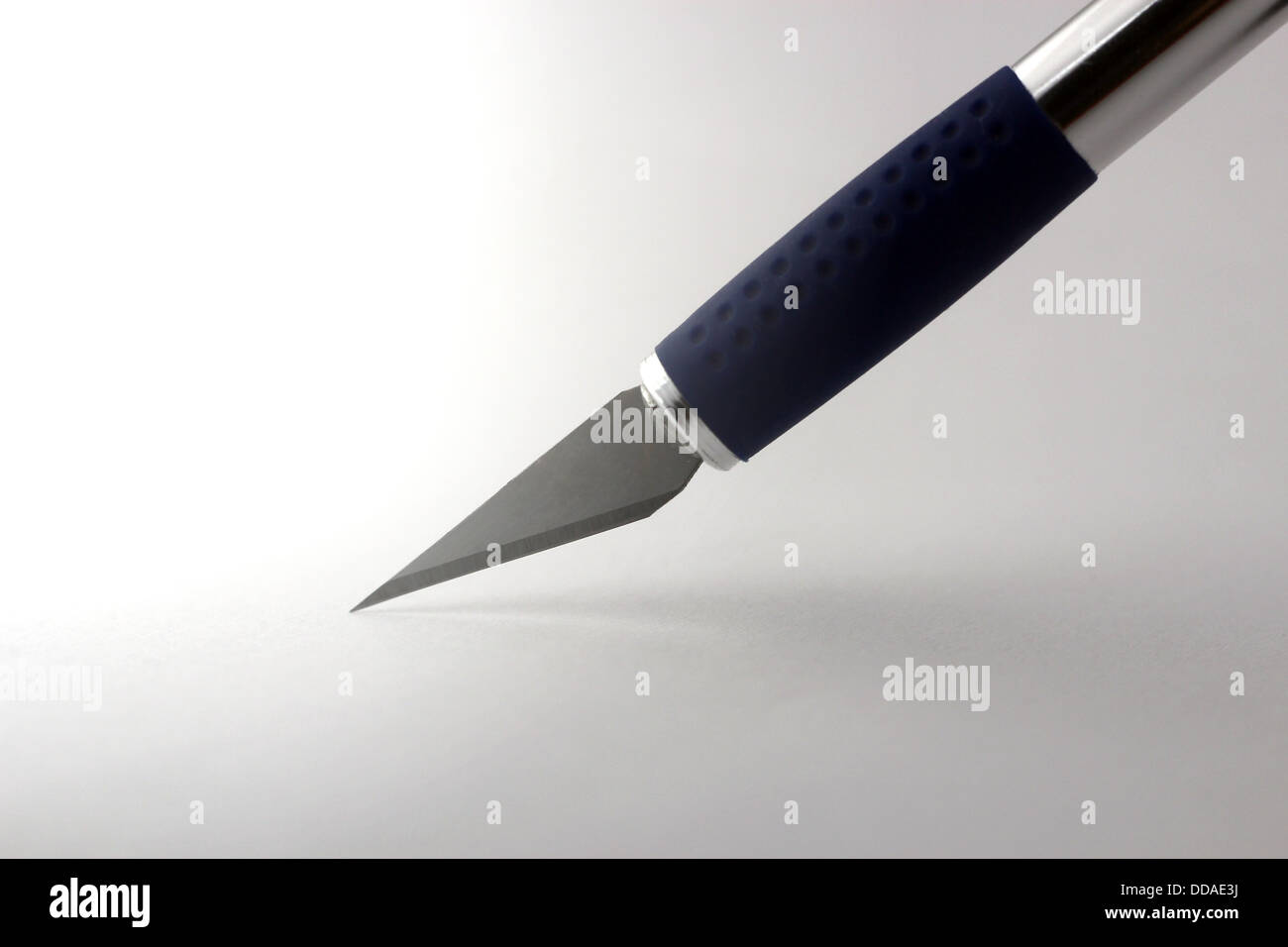 isolated sharp razorblade cutting sheet of blank paper Stock Photo - Alamy