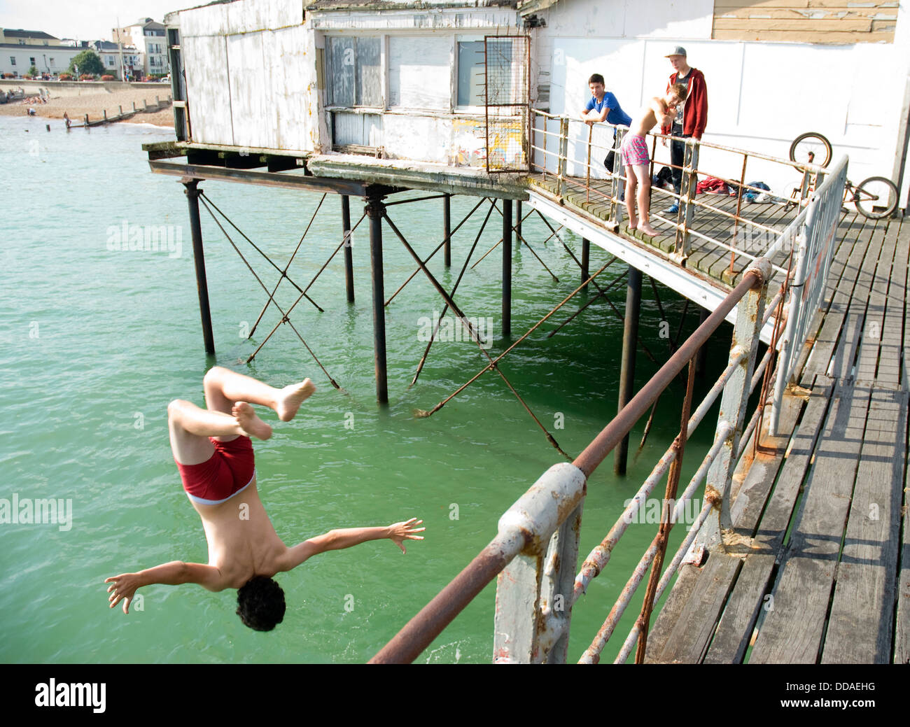 Boy jumping off pier hi-res stock photography and images - Alamy