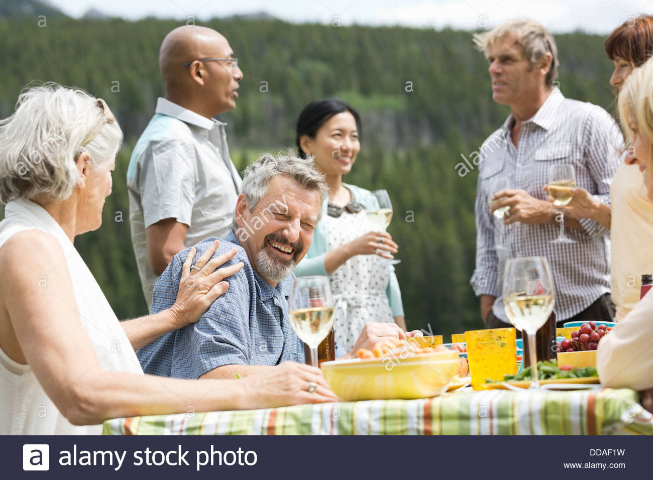 Mature couple goofing around at an outdoor picnic Stock Photo - Alamy