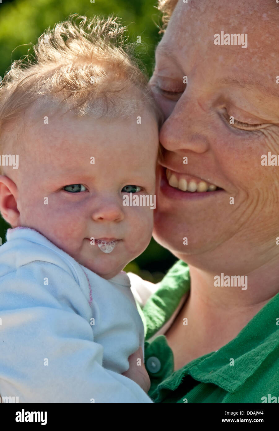 This is a natural looking mother and baby portrait. They are enjoying ...