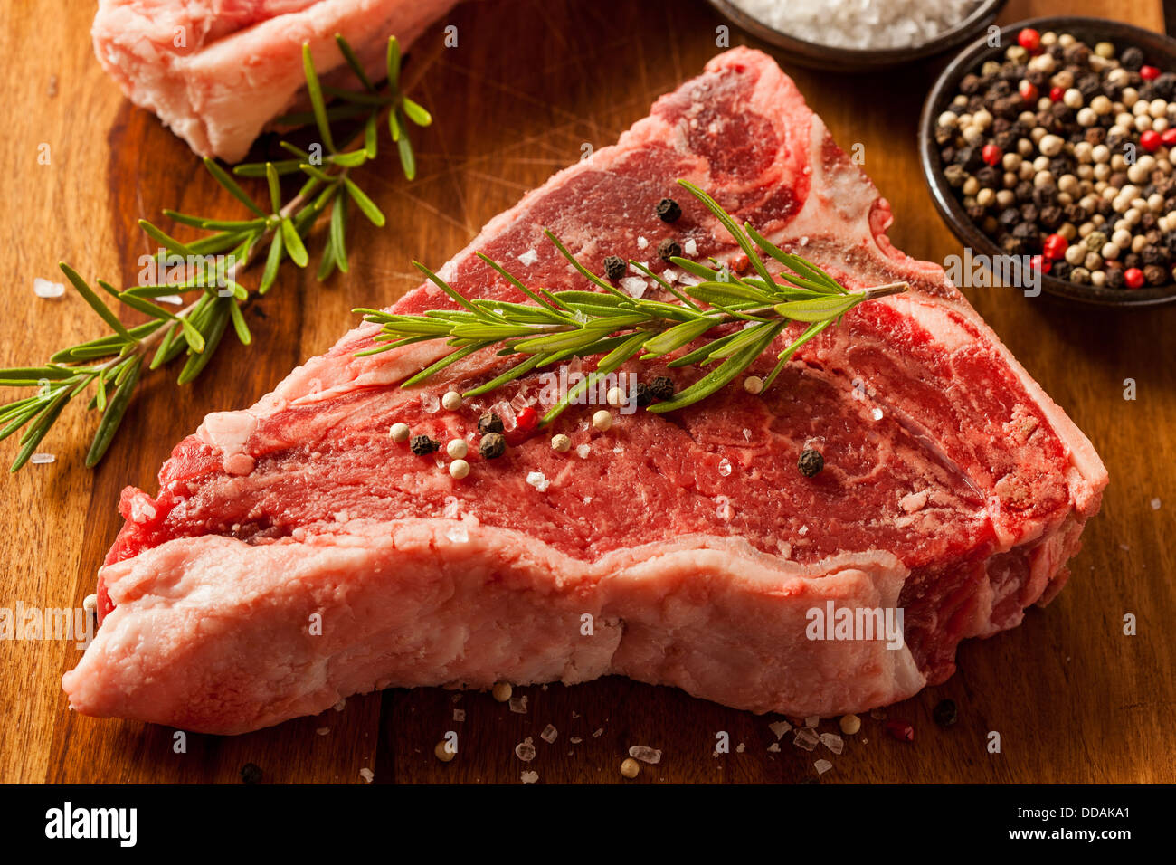 Thick Raw T-Bone Steak with Seasoning and Rosemary Stock Photo - Alamy