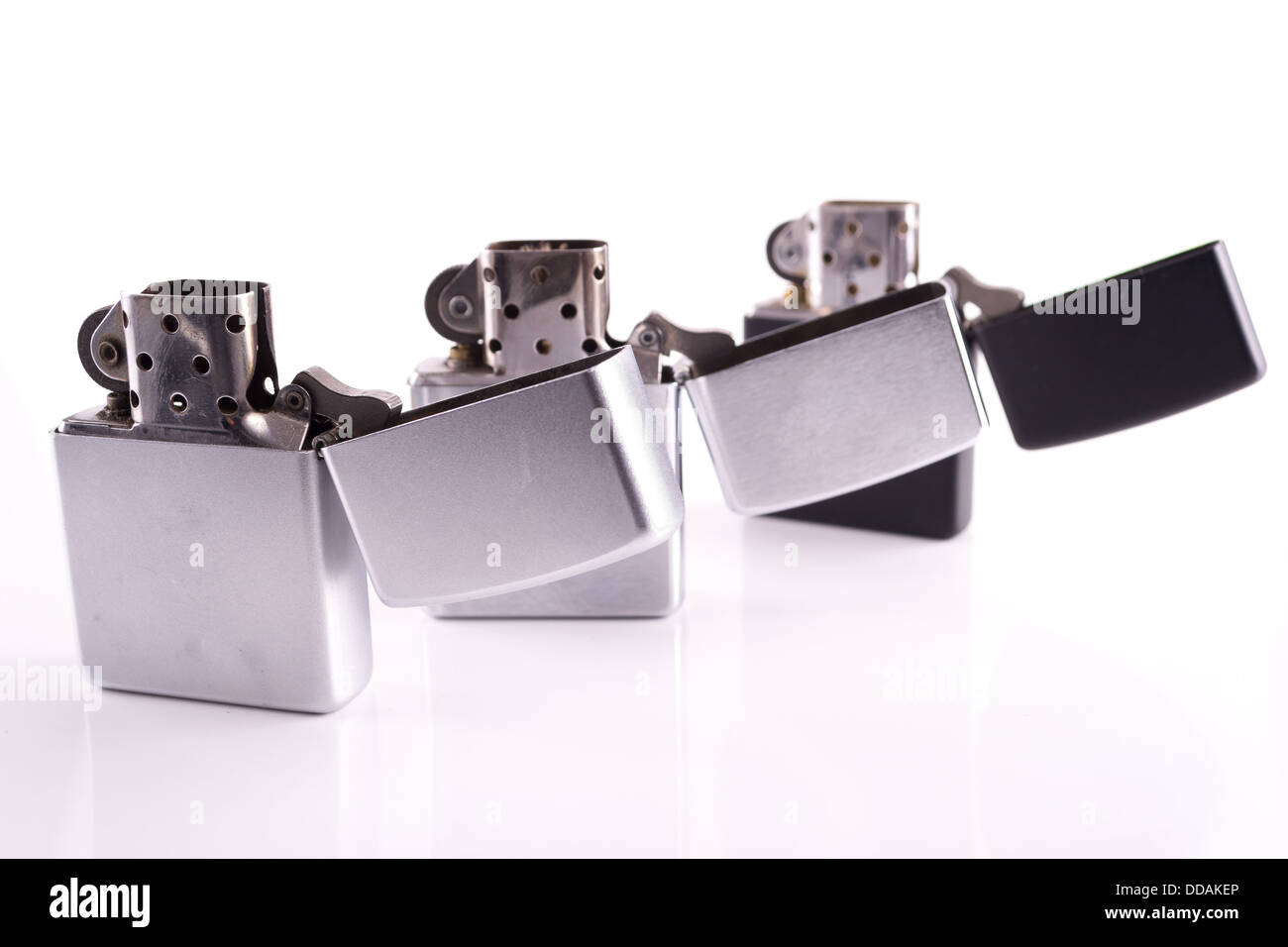 Silver metal zippo lighters on white Stock Photo - Alamy