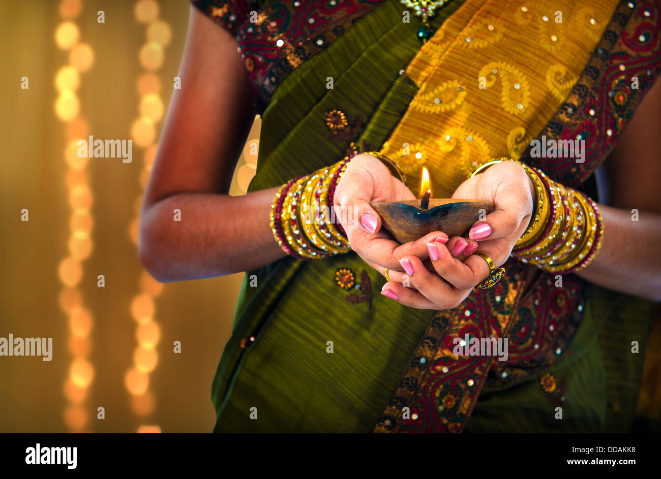diwali or deepavali photo with female holding oil lamp during festival ...
