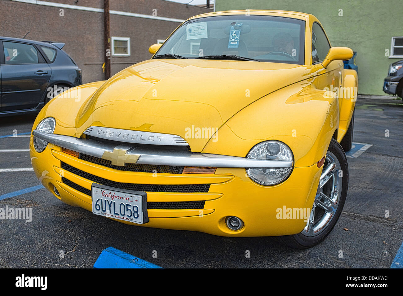 Yellow hot rod car parked on street Stock Photo - Alamy