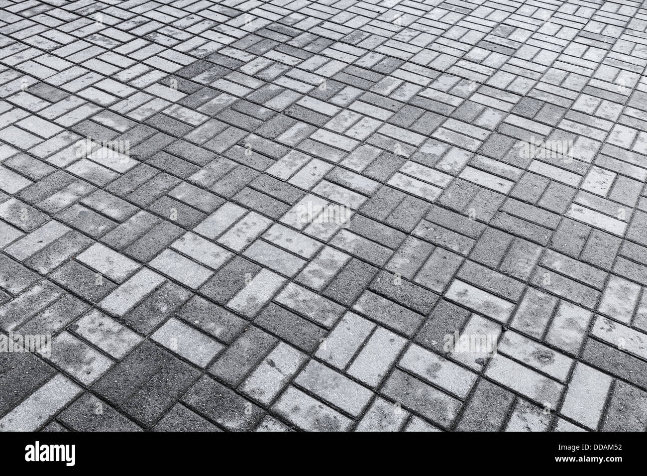 Background texture of gray modern cobblestone road with wet and dry ...