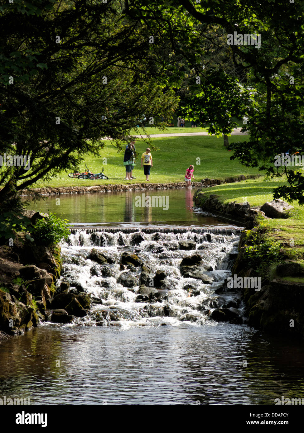 A small waterfall and the River Wye flowing through Buxton Pavilion ...